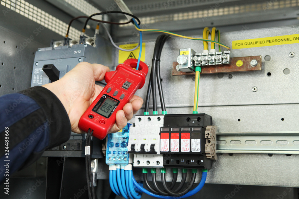 Electrician engineer work tester measuring voltage and current of power ...