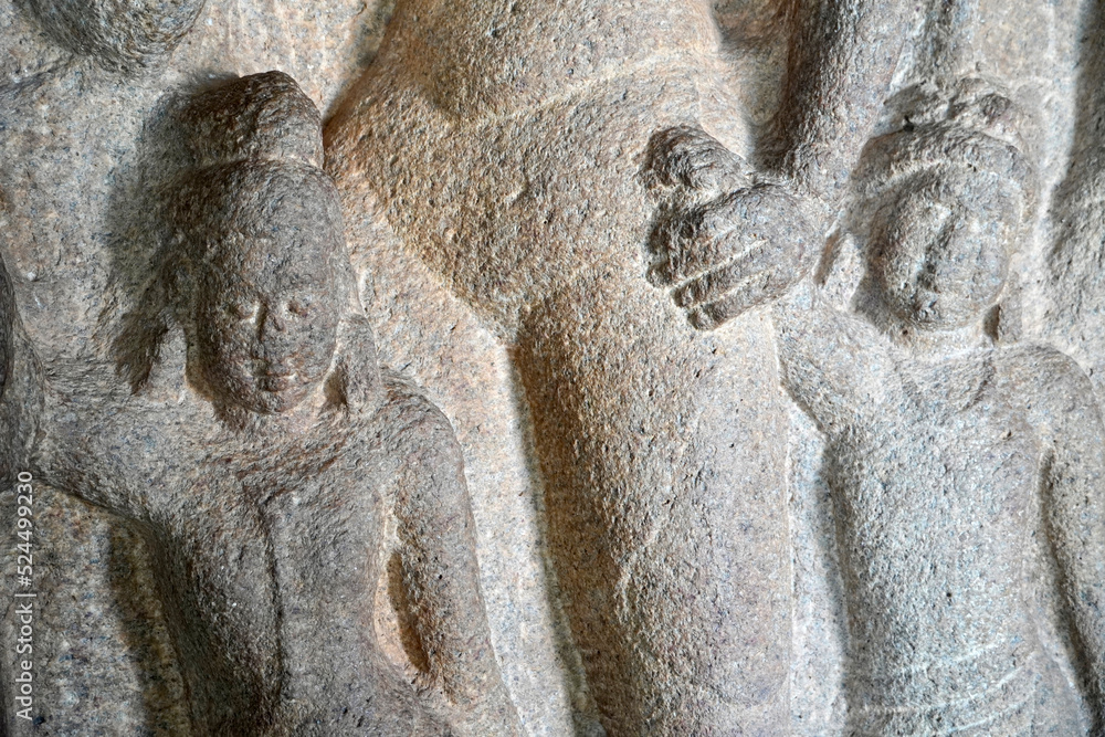 Human rock relief sculptures carved in the rock cut ancient cave temple in Mahabalipuram ...