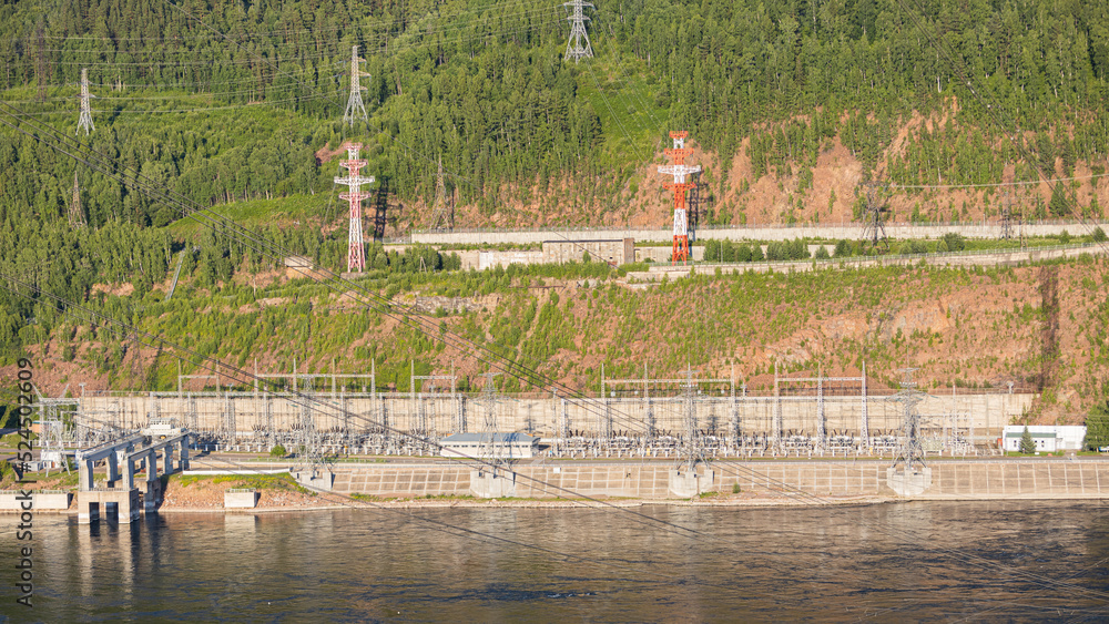 Electrical substation on the riverbank for hydroelectric power station ...