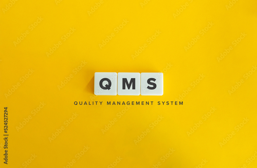 Quality Management System (QMS) Banner. Block Letter Tiles on Yellow ...