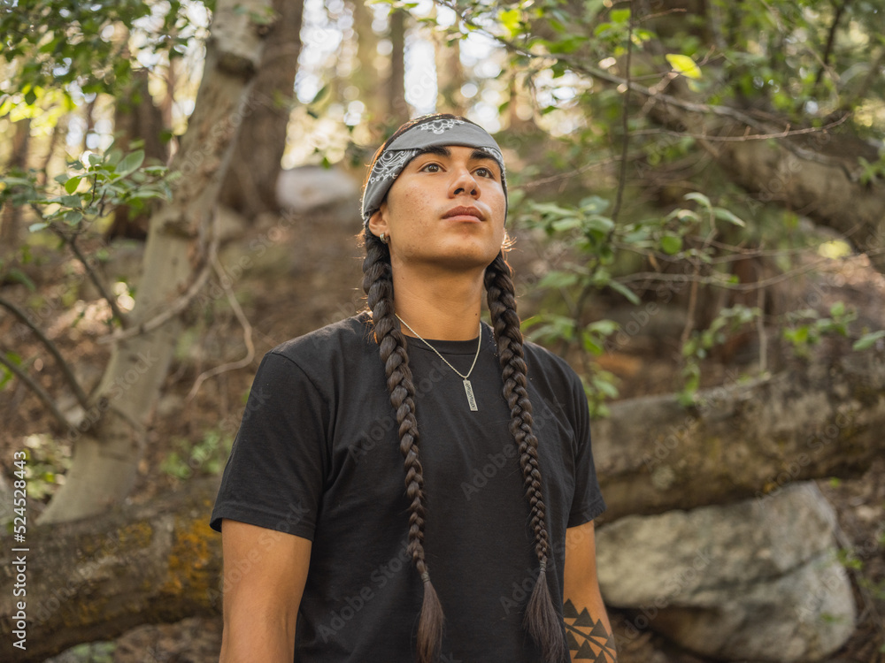 Indigenous young man hiking in nature Stock Photo | Adobe Stock