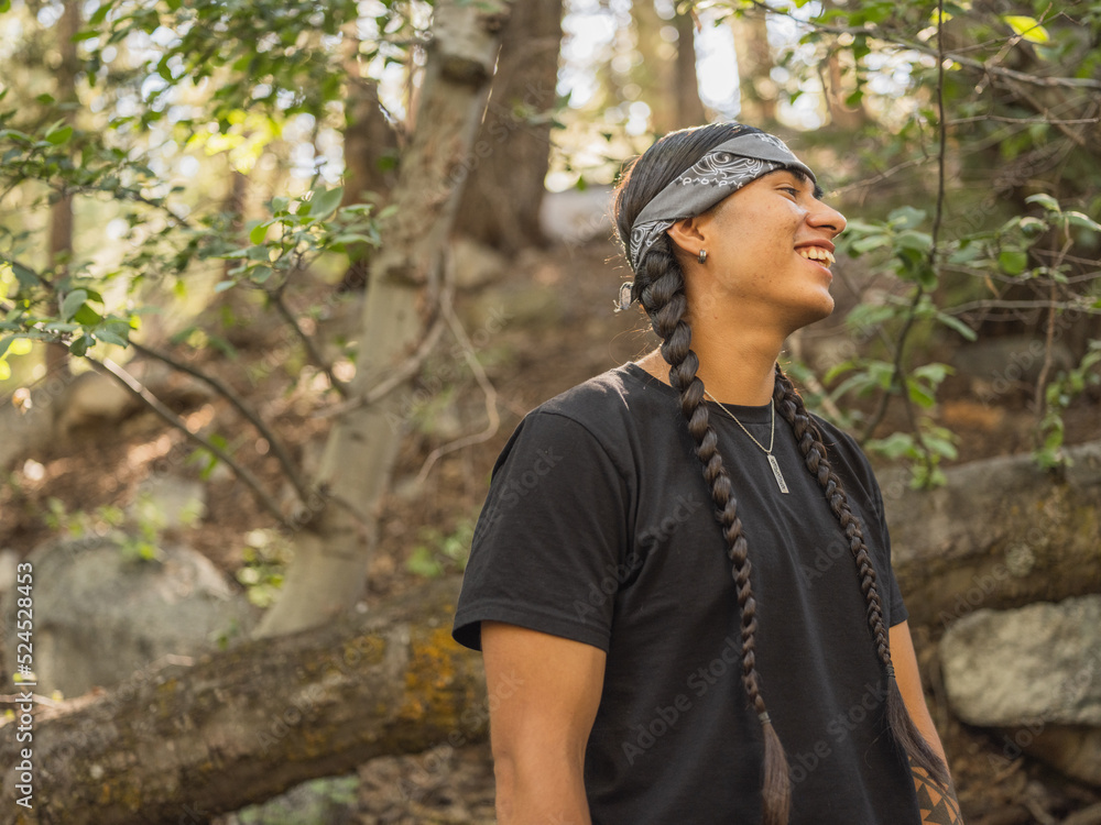 Indigenous young man hiking in nature Stock Photo | Adobe Stock