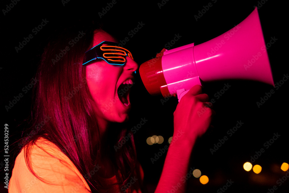Young woman screaming in loudspeaker Stock Photo | Adobe Stock