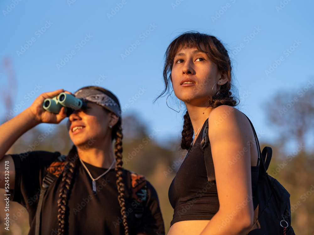 Young native friends birding in the forest during sunset Stock Photo ...
