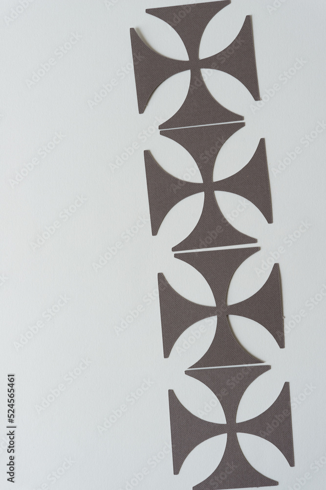 gray paper crosses arranged on blank paper Stock Photo | Adobe Stock