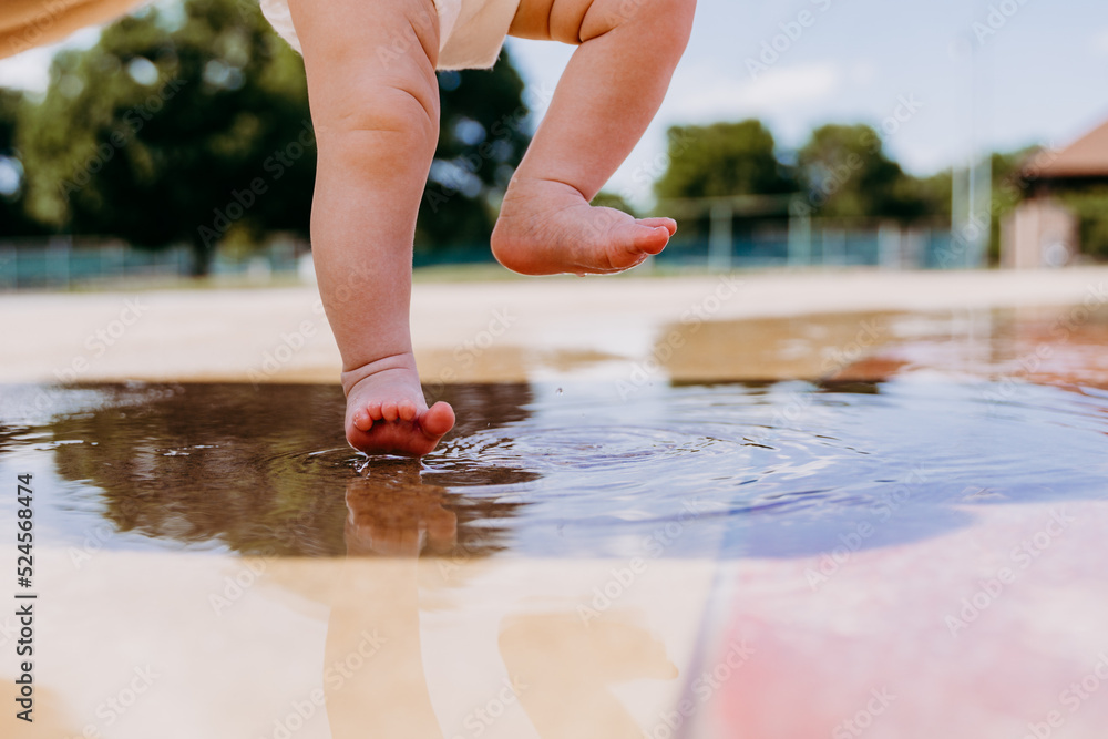 Baby feet splash in water for first time Stock Photo | Adobe Stock