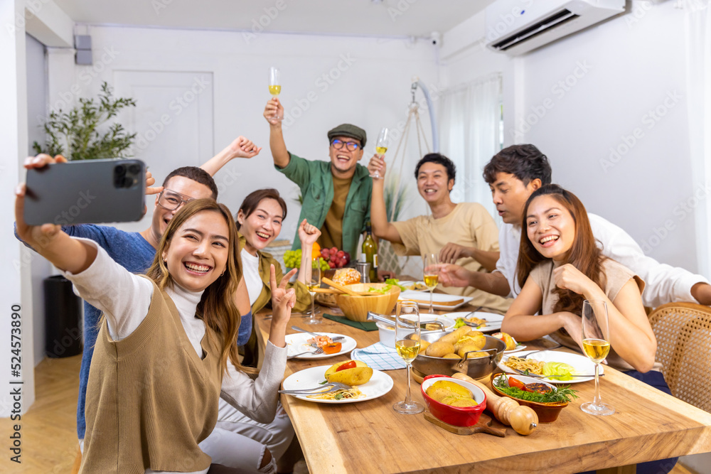 Group of Cheerful Asian man and woman friends enjoy dinner party using ...
