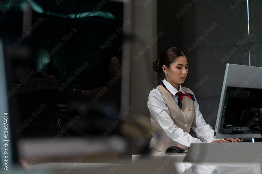 Asian woman airline ground staff working at of check in counter in ...