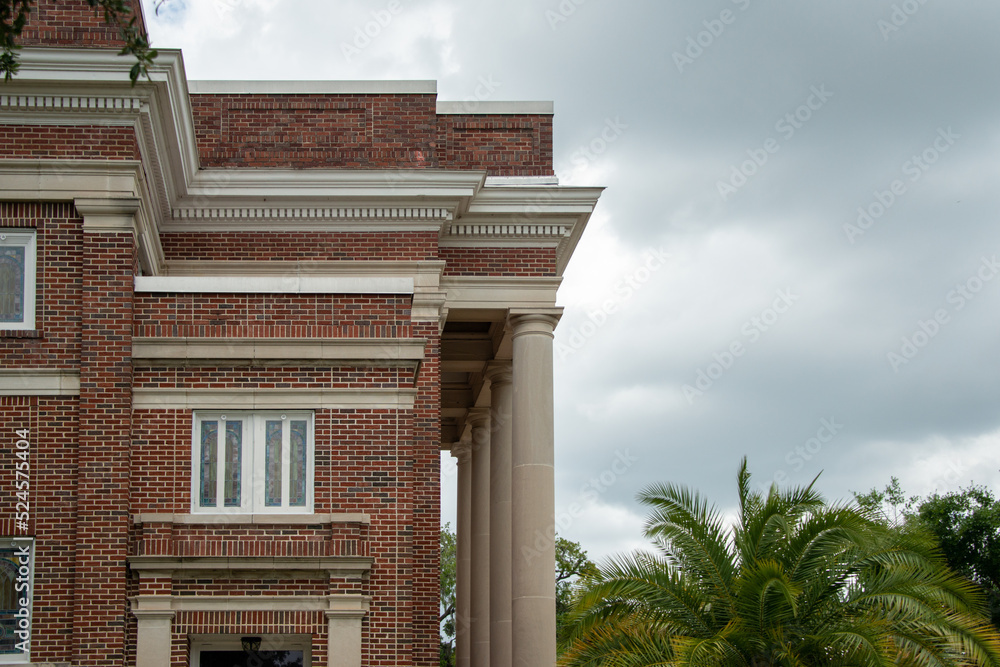 The corner view of a vintage brown brick building with tan colored ...