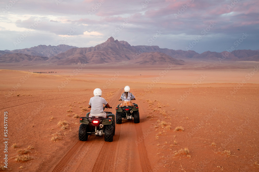 tourists on quad bikes riding through the desert in namibia Stock Photo ...