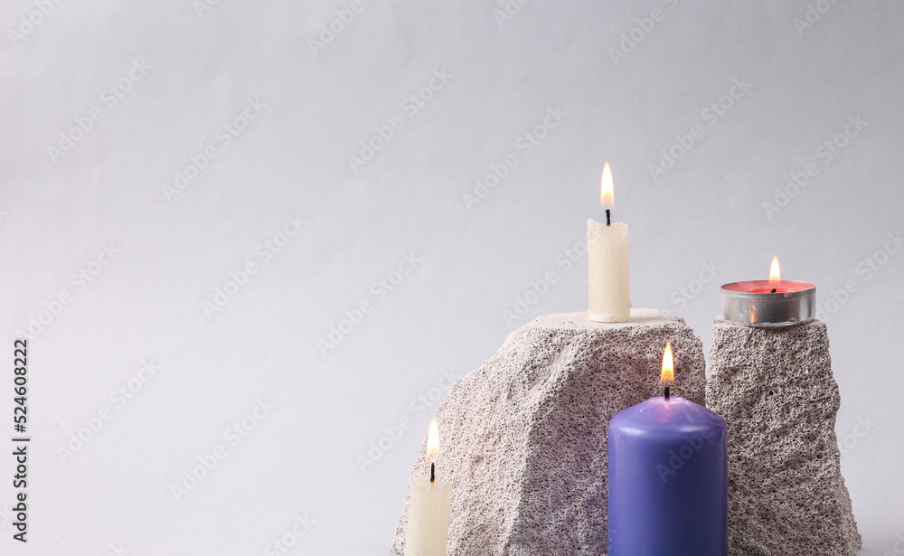 Minimalistic aesthetic scene of flaming wax candles of different types ...