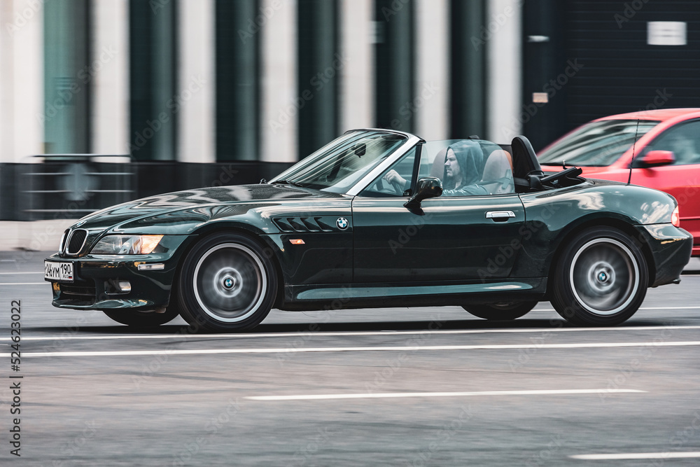 BMW Z3 car rides on street on high speed. Black roadster with inline ...