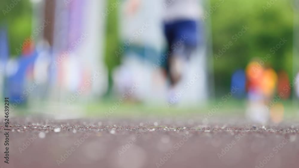 Blurry video view from behind runner running with acceleration finish ...
