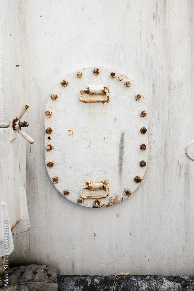 Details of an old iron door with rivets, rust and a twist lock, on the ...
