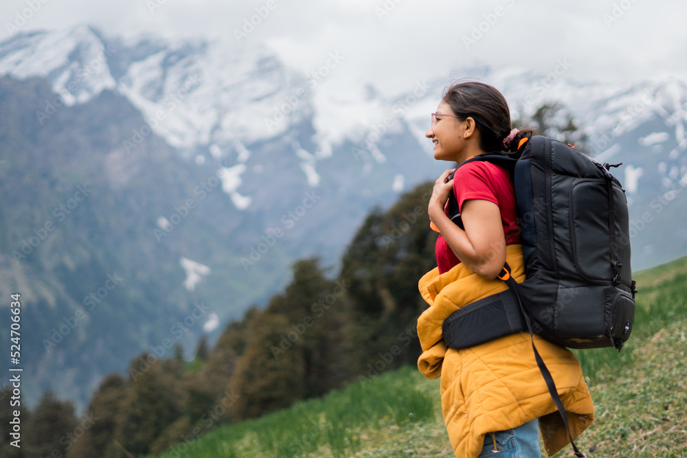 Teenager Indian girl hiking on mountain with backpack in Manali, Himachal Pradesh, India. Female ...