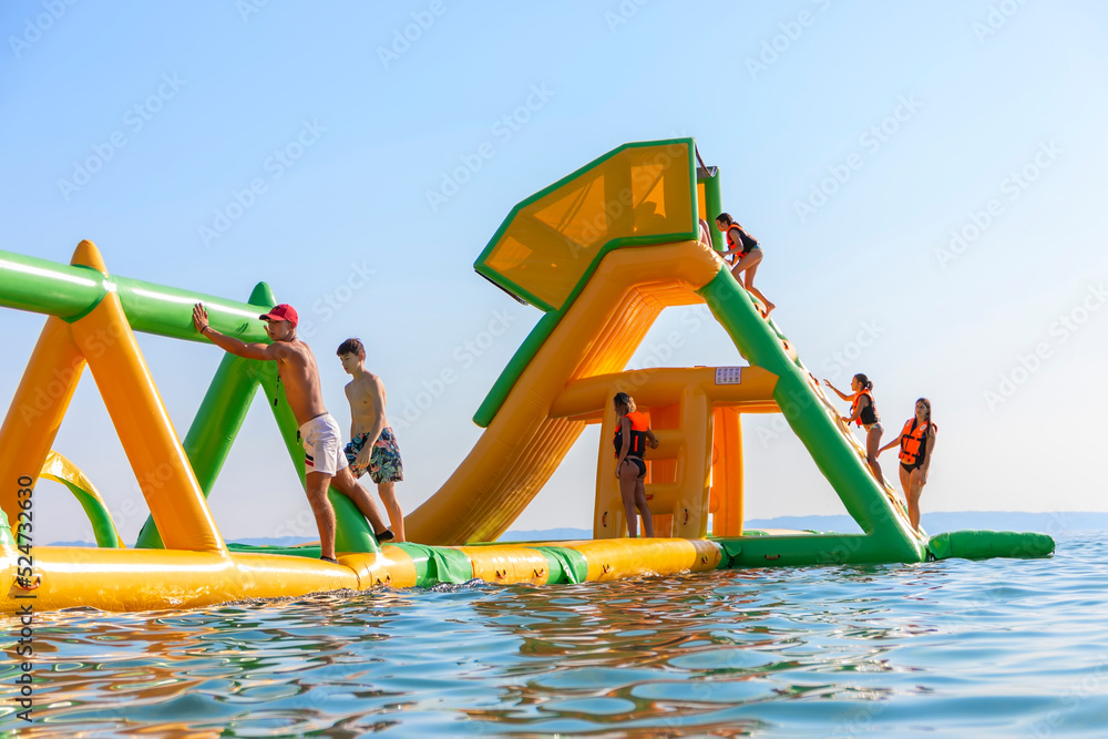 Inflatable bounce castle floating in water.Aqua park for children ...