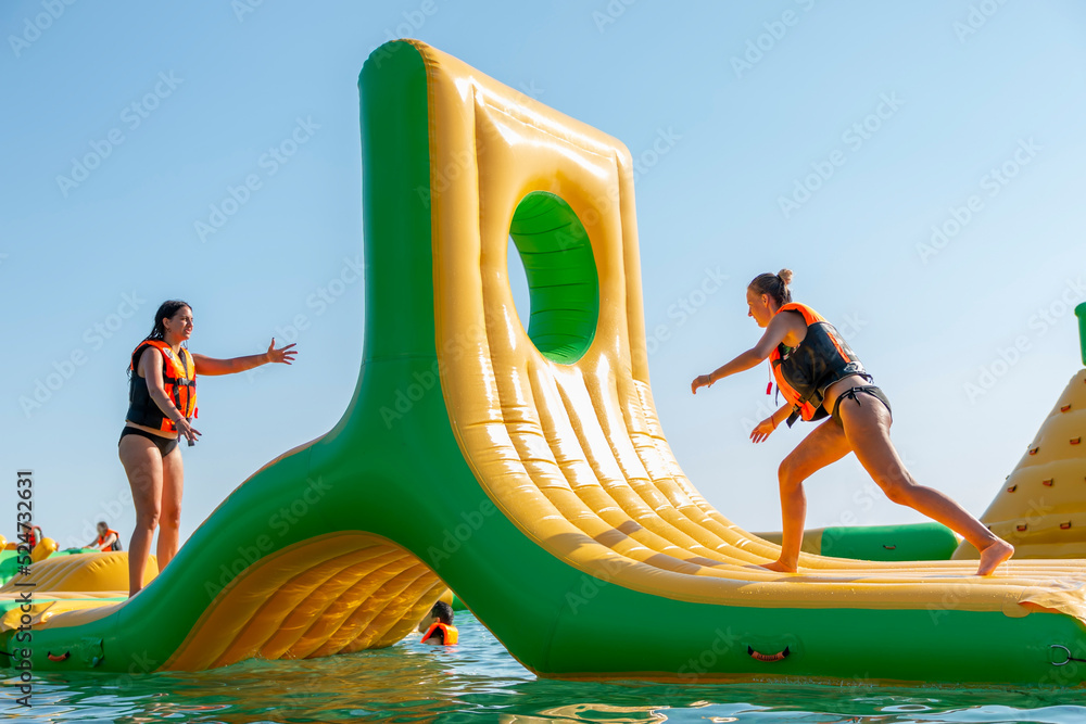 Inflatable bounce castle floating in water.Aqua park for children ...