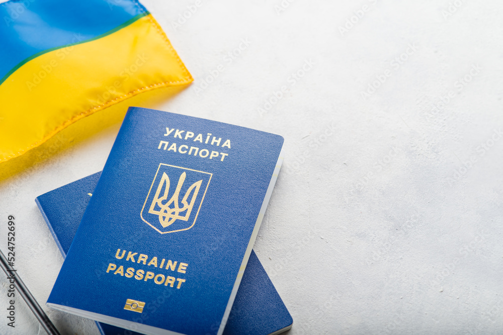 Yellow-blue Ukrainian flag and two biometric Ukrainian passports on a ...