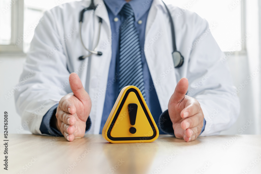 Warning symbol in hand of doctor. Doctor's warning, Precautions for ...