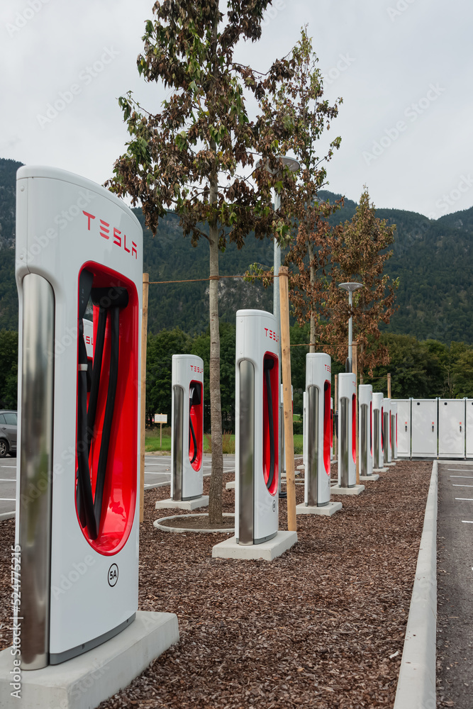 A Tesla electric car supercharger in a commercial parking lot. Stock ...