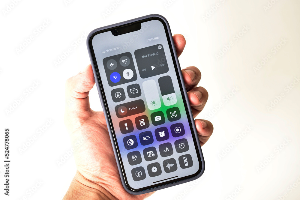 Control center in hand holding iphone 13 isolated on white background ...