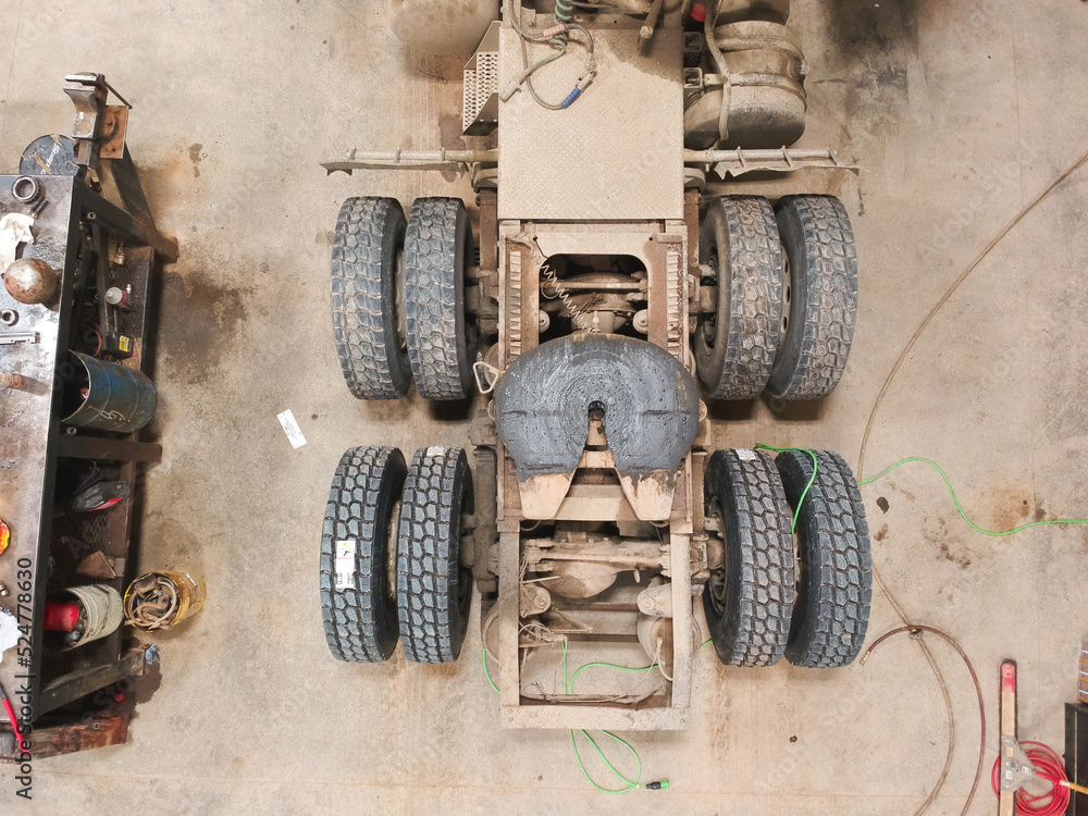 Heavy dually semi-truck wheels and trailer hitch from above Stock Photo ...