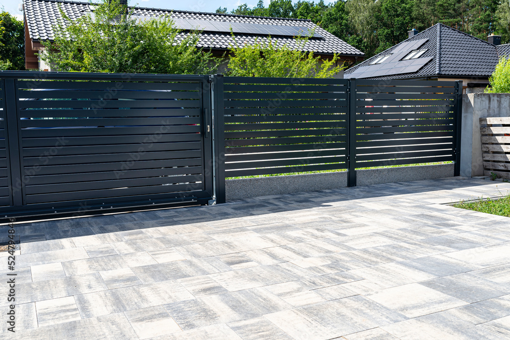 Modern panel fencing in anthracite color, visible sliding gate to the ...