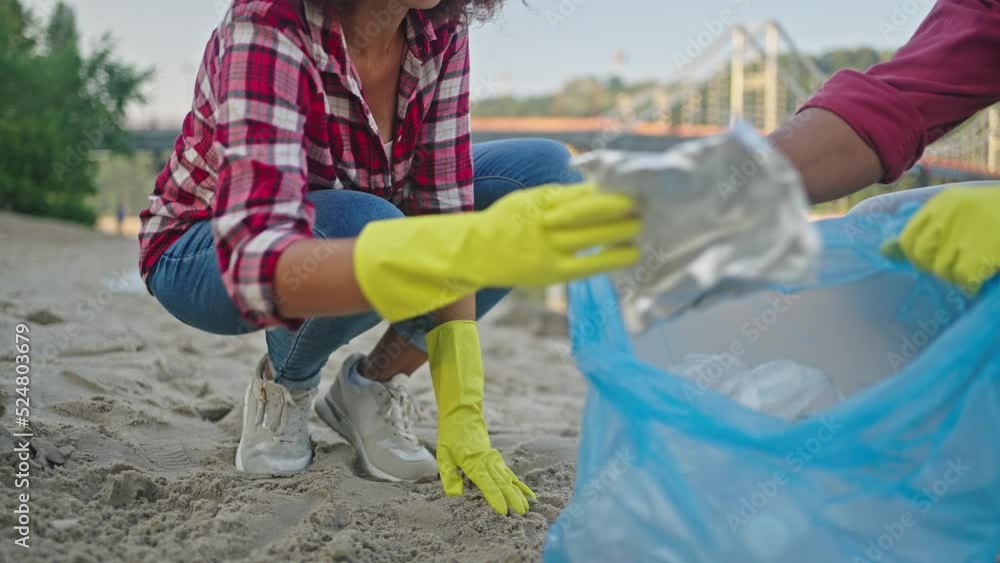 Couple of volunteers gather trash on dirty beach together Stock Video ...