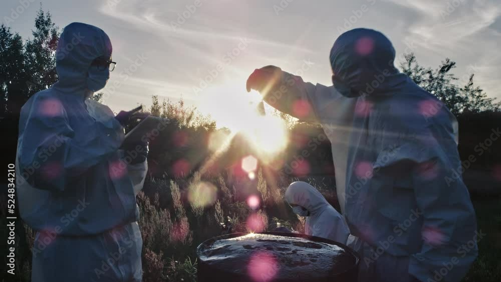 Scientists picking biohazardous samples in the infected area. Wearing ...