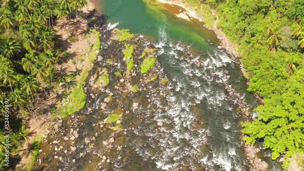 Aerial drone of river Cagayan de Oro flowing through the rainforest and ...