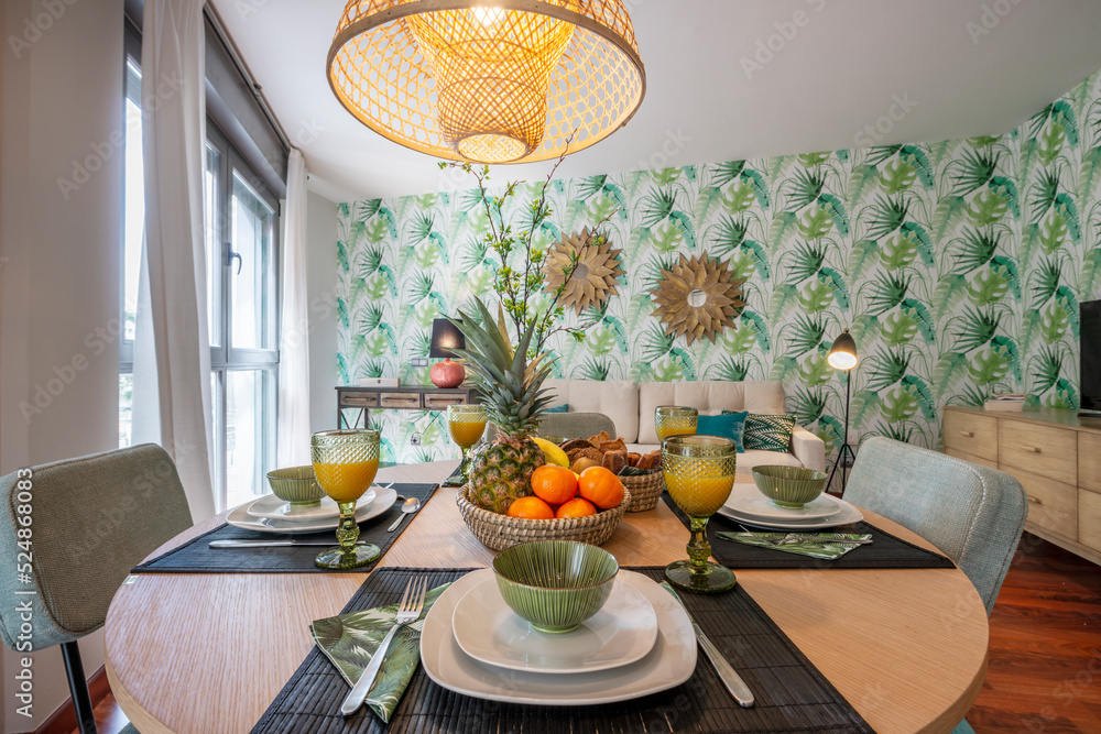 Beautiful round wooden dining table with breakfast service set up with ...