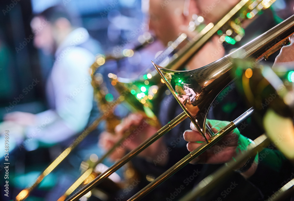 The musical instrument is a trumpet in the hands of a musician ...