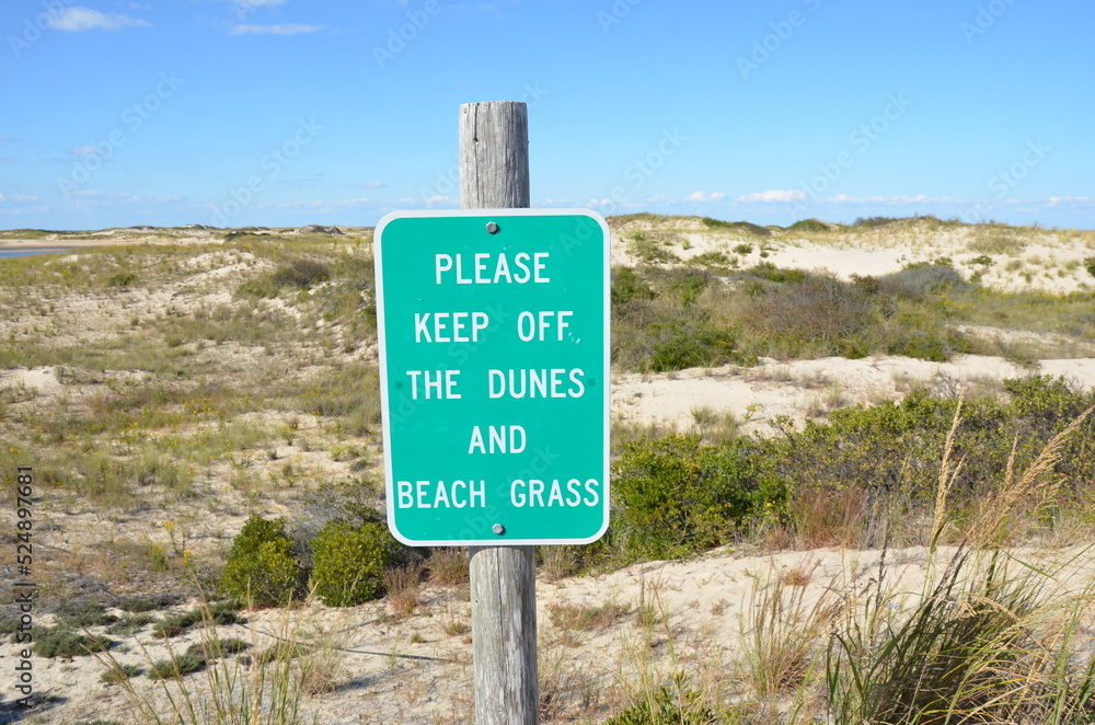 wood fence and sand dunes at the beach with please keep off sign Stock ...
