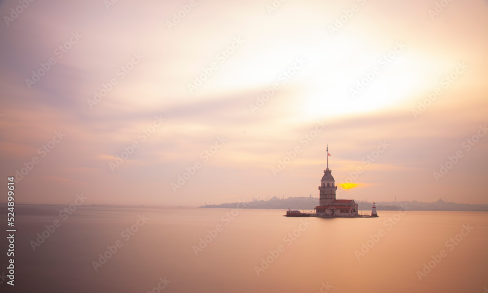 Fiery sunset over Bosphorus with famous Maiden's Tower (Kiz Kulesi ...