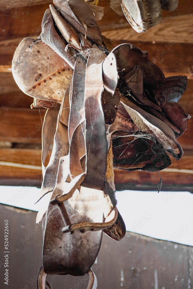 This is a digitally enhanced image of an antique horse saddle hanging ...