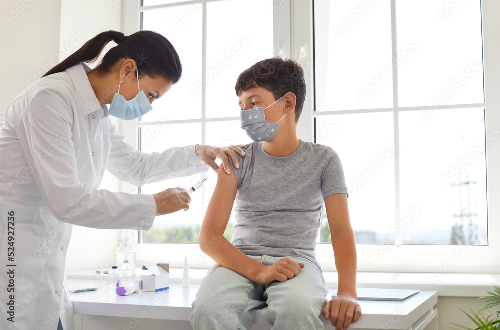 Doctor or nurse gives shot to school boy. Child gets injection in new ...