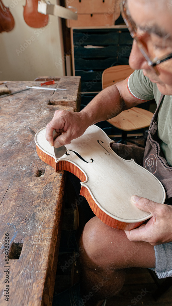 luthier carving and sculpting the f holes a violin with a knife Stock ...