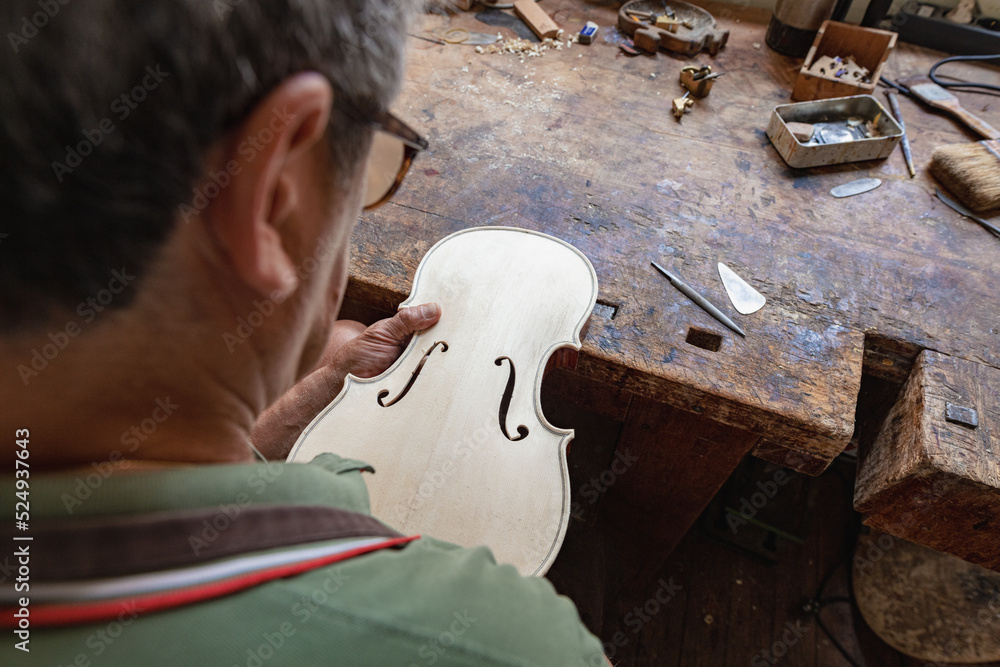 luthier carving and sculpting the f holes a violin with a knife Stock ...