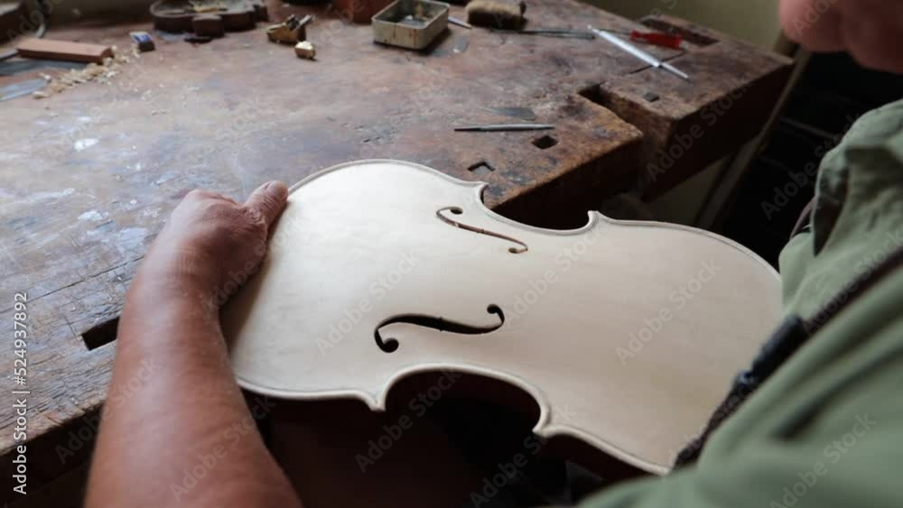 luthier carving and sculpting the f holes a violin with a knife Stock ...