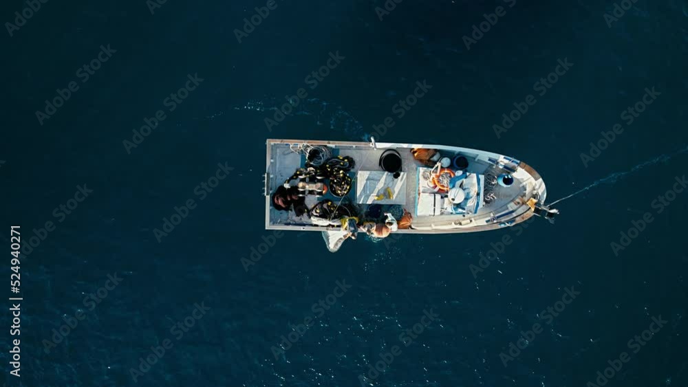 Fishers pulling out netting bags with sardines from sea in plastic ...