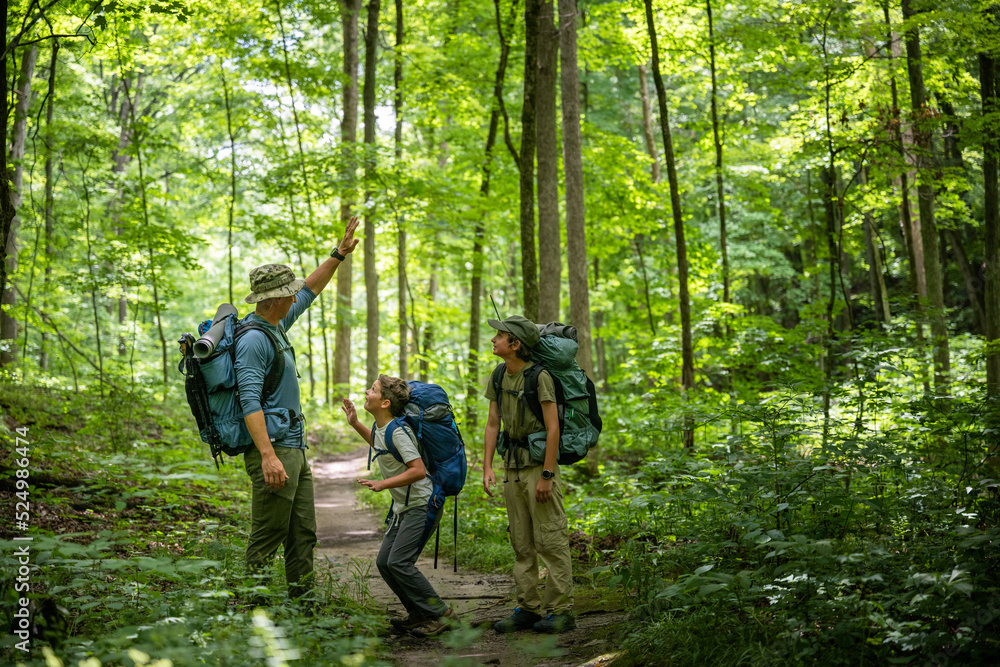 Air Force service member heads out on a hike with his sons on a ...