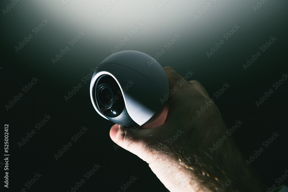 Male hand holding CCTV surveillance camera in hand - spying concept 24 ...