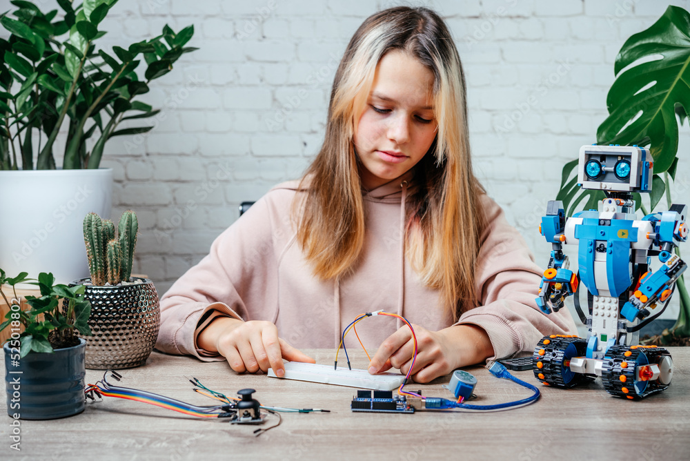A Teenager Girl Plugging Cables To Sensor Chips While Learning Arduino ...