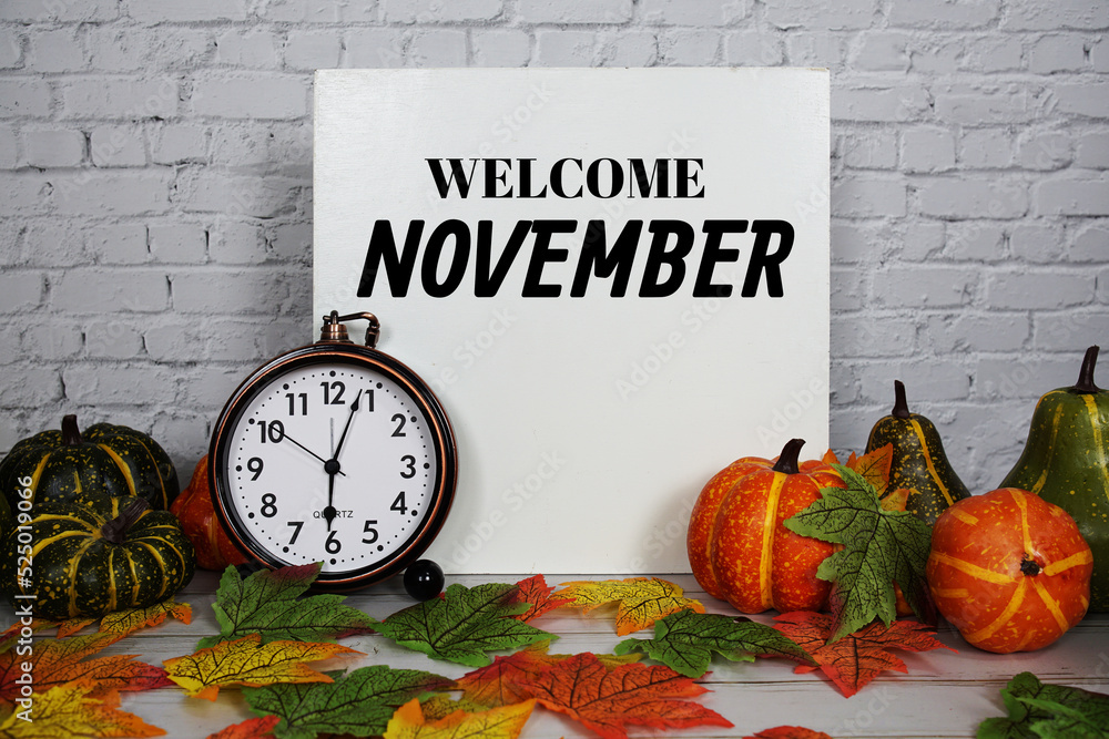 Welcome November text message with pumpkin and maple leaf decoration on ...