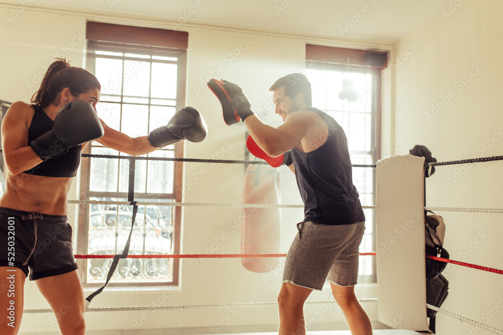 Female boxer training with her personal trainer at the gym Stock Photo ...