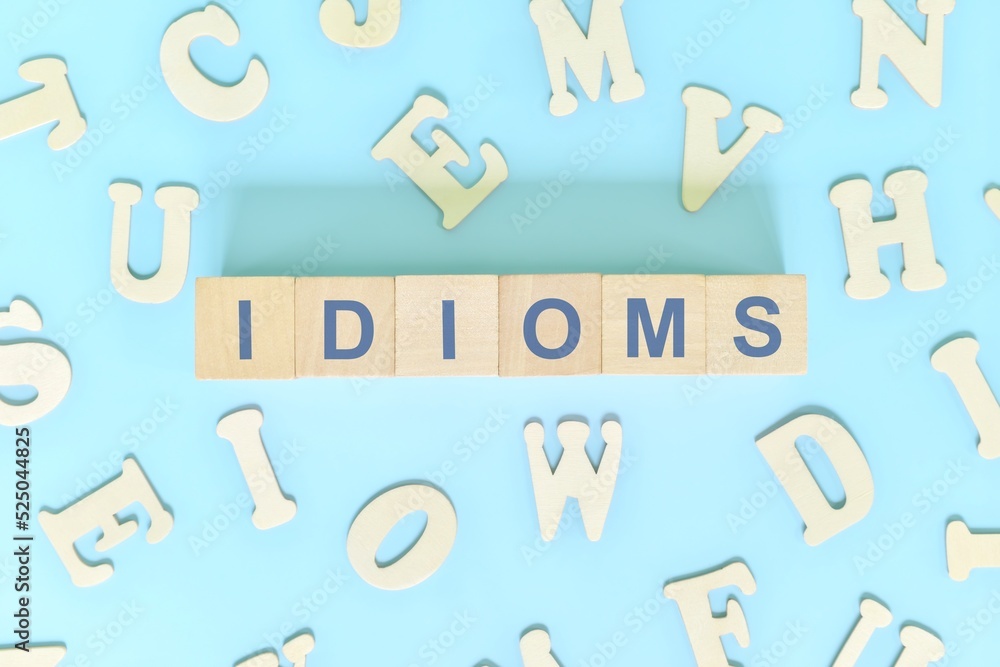 Idioms or idiom concept in English grammar class lesson. Wooden blocks ...