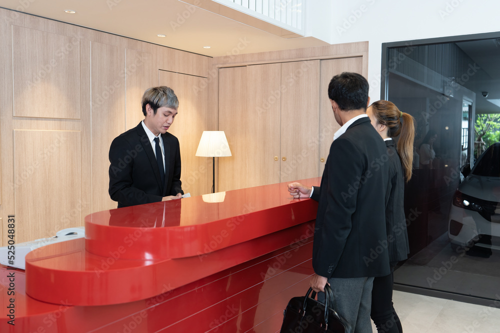 In the hotel lobby guest reception counter front desk staff greeting ...