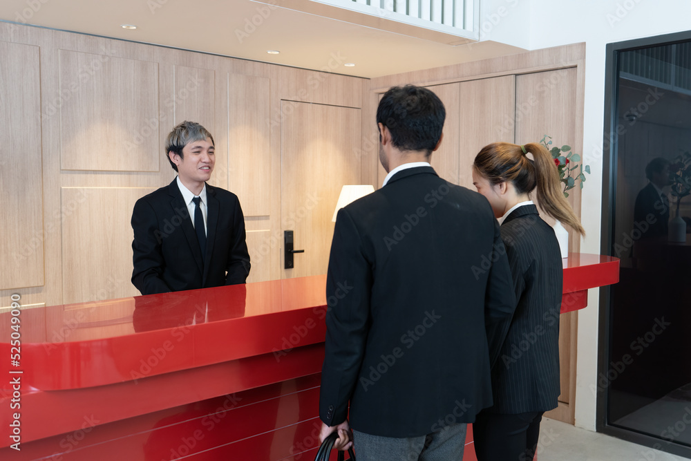 In the hotel lobby guest reception counter front desk staff greeting ...