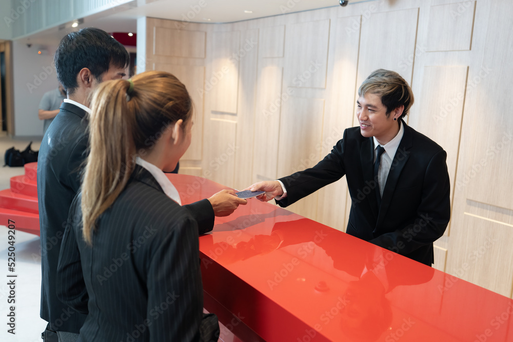 In the hotel lobby guest reception counter front desk staff greeting ...