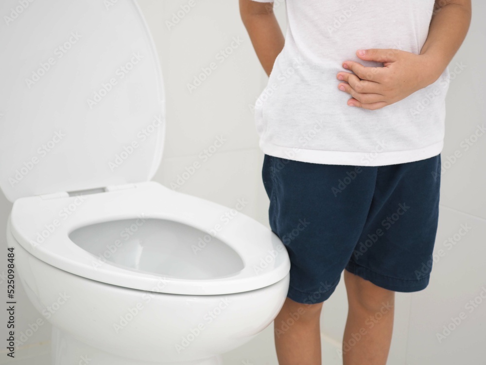 Kid boy stood in the bathroom. With severe diarrhea Use both hands to ...